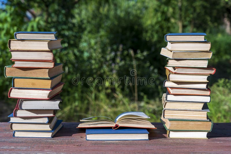 Stack of Books on Wooden Table Over Nature Background, Outdoors Stock ...