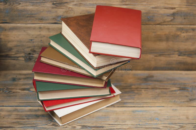 Stack of Books on Wooden Table Over Rustic Background with Copy Space ...