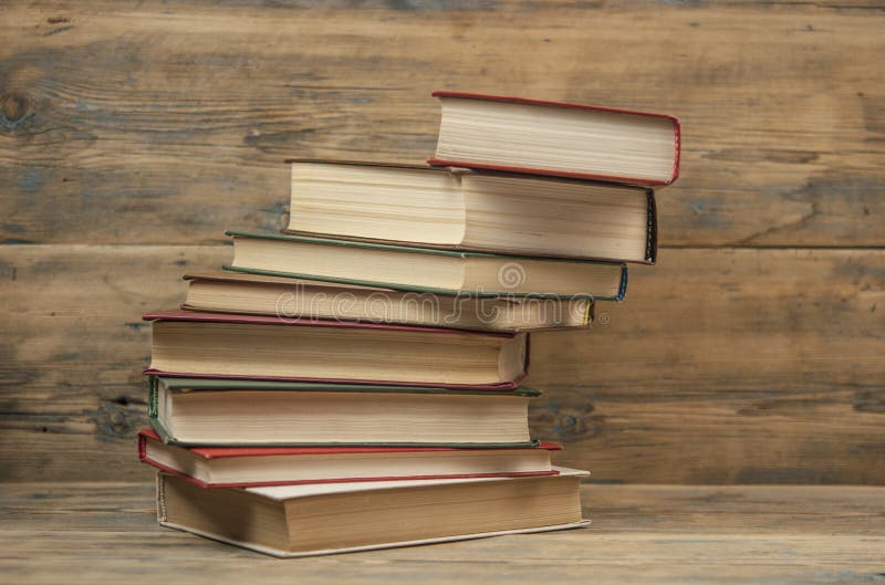Stack of Books on Wooden Table Over Rustic Background with Copy Space ...