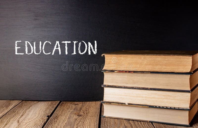 Stack of Books with the Word Education Written on a Chalkboard Stock ...