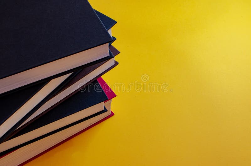 Stack of Books on a Yellow Background Stock Photo - Image of hardcover ...