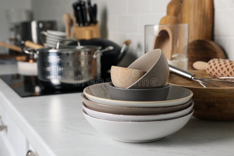 Stack of Bowls and Different Cooking Utensils on Countertop in Kitchen ...
