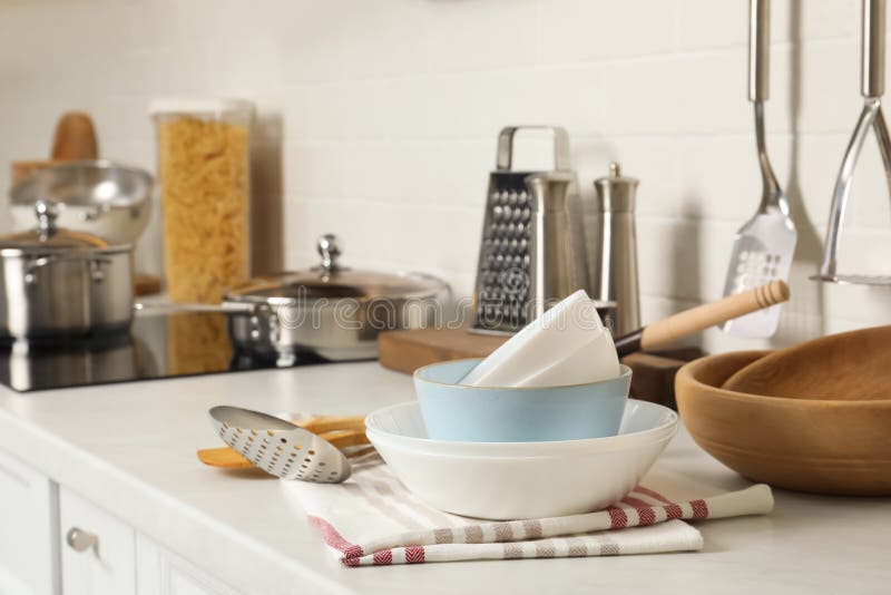Stack of Bowls and Different Cooking Utensils on Kitchen Counter Stock ...