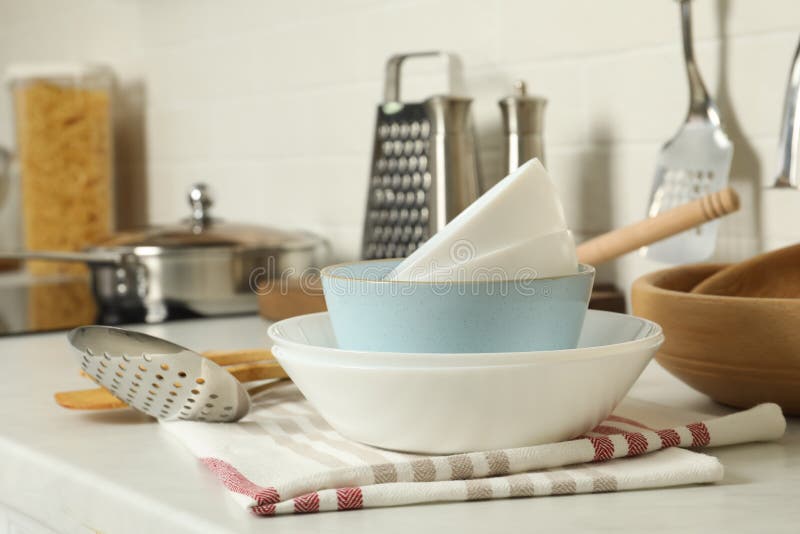 Stack of Bowls and Different Cooking Utensils on Kitchen Counter Stock ...