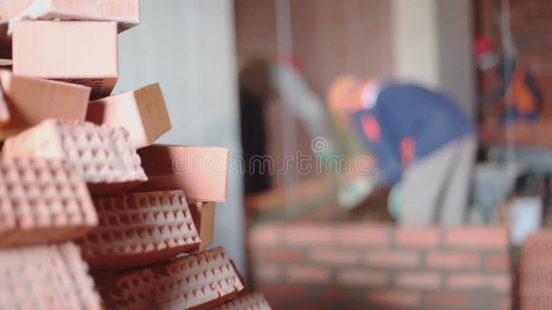 Stack of Bricks at Background of Few Workers Build Stock Video - Video ...