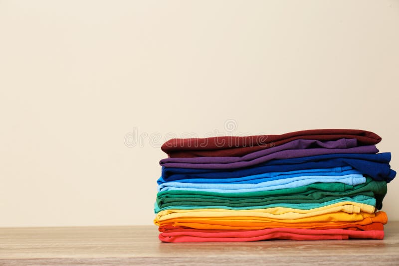 Stack of Bright Folded Clothes on Table Stock Photo - Image of clothing ...