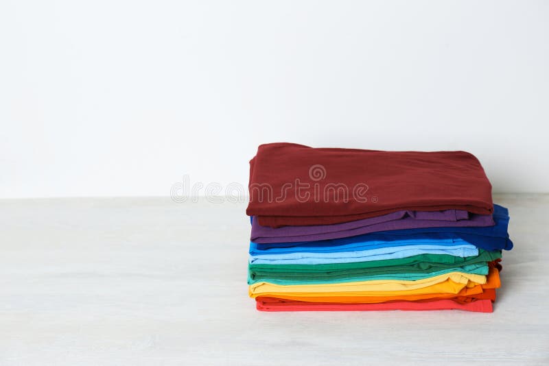 Stack of Bright Folded Clothes on Table Stock Photo - Image of clothes ...