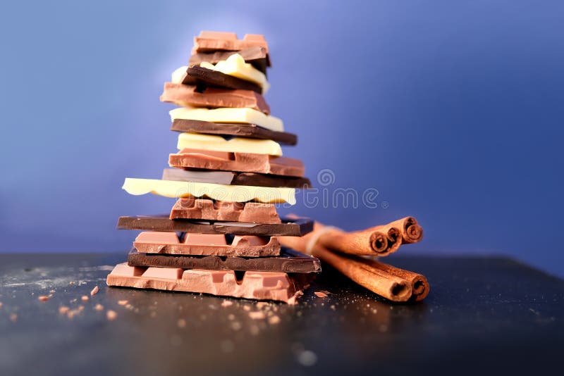 Stack of Broken Bars of White, Milk, Dark Chocolate on a Slate Board, a ...