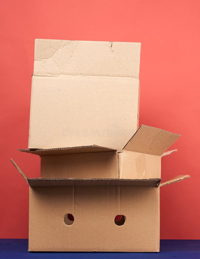 Stack of Cardboard Boxes of Brown Kraft Paper on a Wooden Table Stock ...