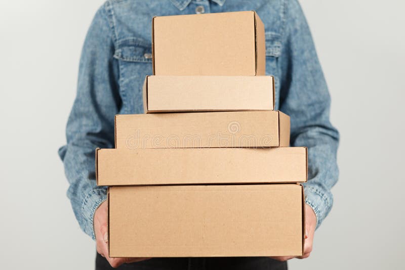 A Stack of Cardboard Boxes in the Hands of a Courier. Delivery of ...