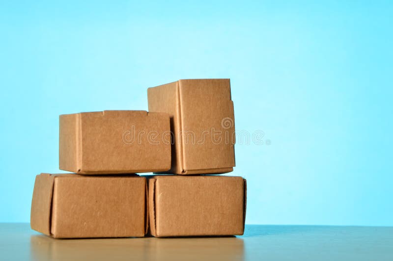 Stack of Cardboard Boxes Isolated on a Blue Background. Stock Market ...