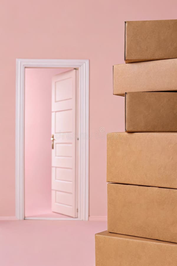 Stack of Cardboard Boxes in Minimalistic Pink Room with Open Door Stock ...