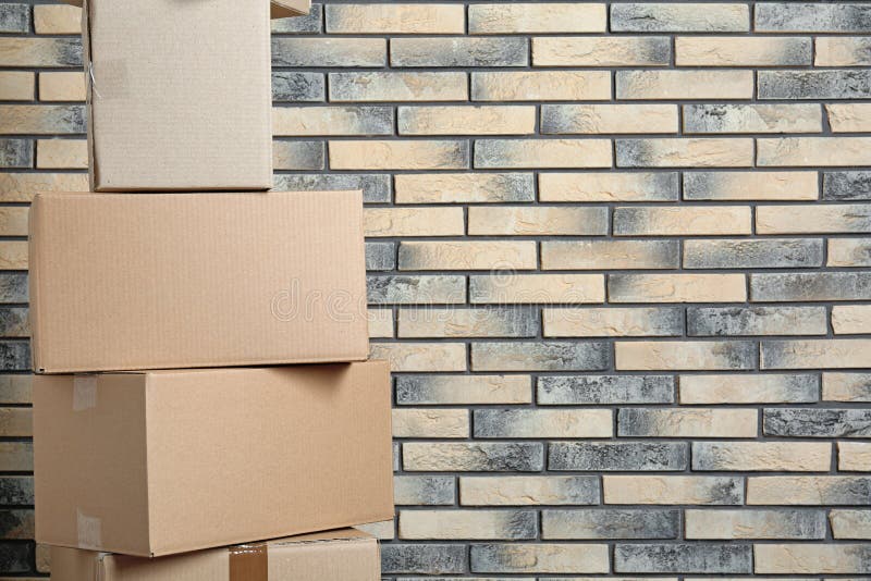 Stack of Cardboard Boxes Near Brick Wall Stock Photo - Image of freight ...