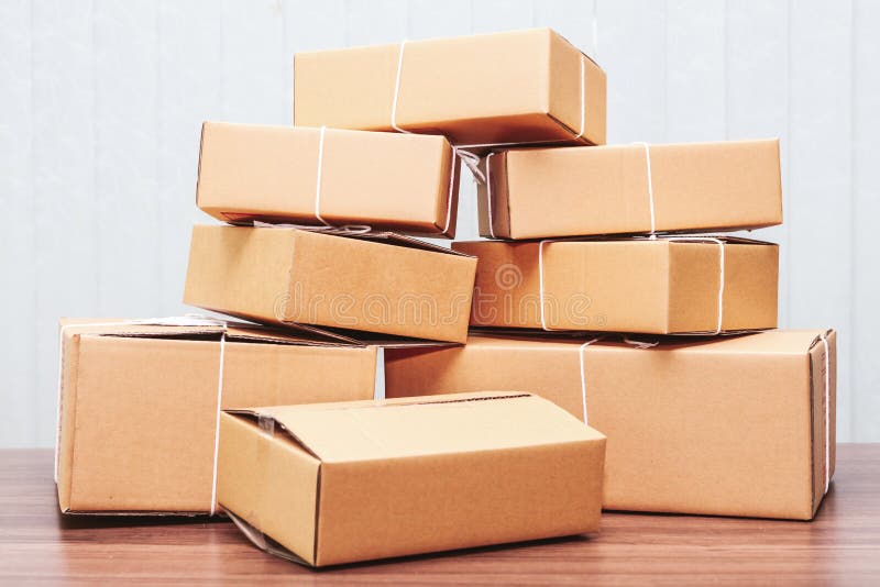 Stack of Cardboard Boxes on Wooden Table Stock Photo - Image of office ...