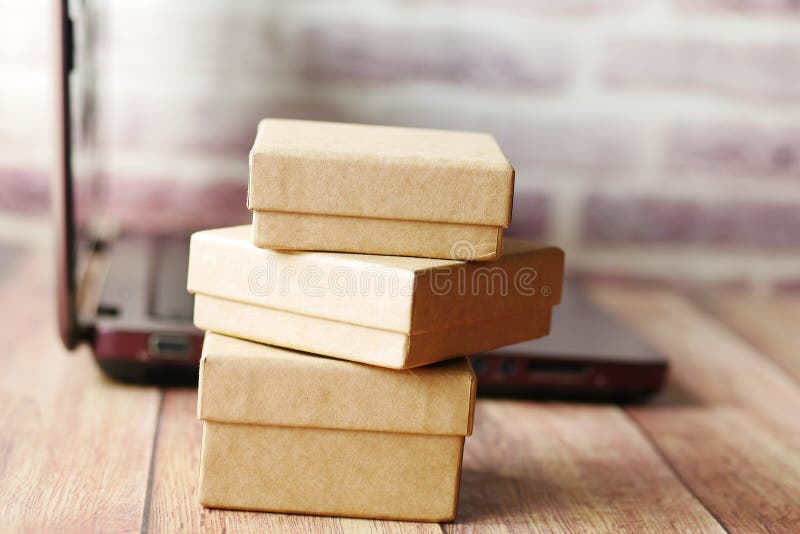 Stack of Cardboard Parcels and Laptop on Table Stock Image - Image of ...