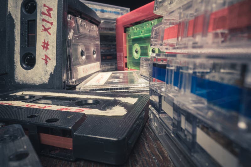 Stack of Cassettes and Spinning in Player. Cassette and Player Stock ...