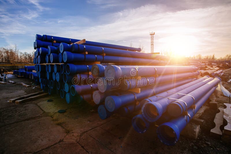 Stack of Cast Iron Pipes in Loading Area Waiting for Transportation ...