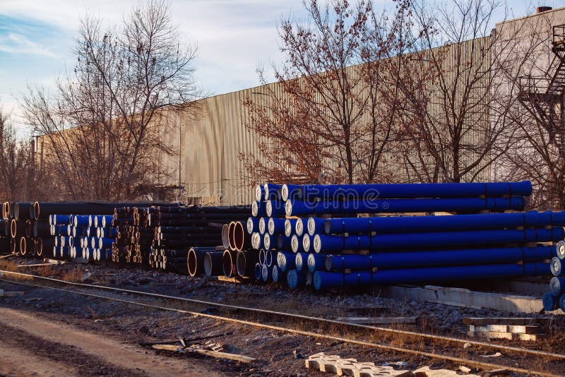Stack of Cast Iron Pipes in Loading Area Waiting for Transportation ...