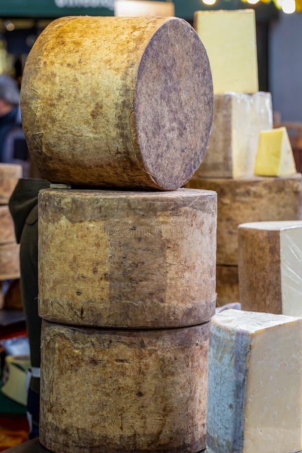 Stack of Cheddar Cheese Wheels on a Market Stall Stock Photo - Image of ...