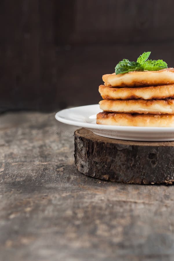 Stack of Cheesecakes on a White Plate and a Dark Wooden Backgrou Stock ...