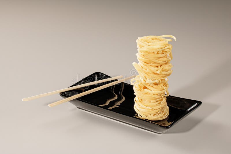 Stack of Chinese Noodles on Black Plate and Bamboo Chopsticks Stock ...