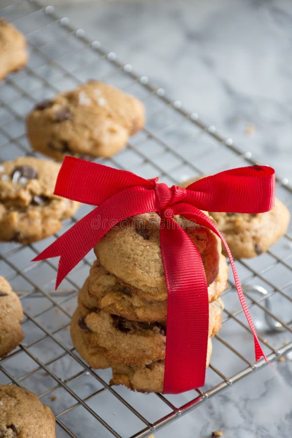 Stack of Chocolate Chip Cookies Tied with a Red Ribbon on Cooling Rack ...