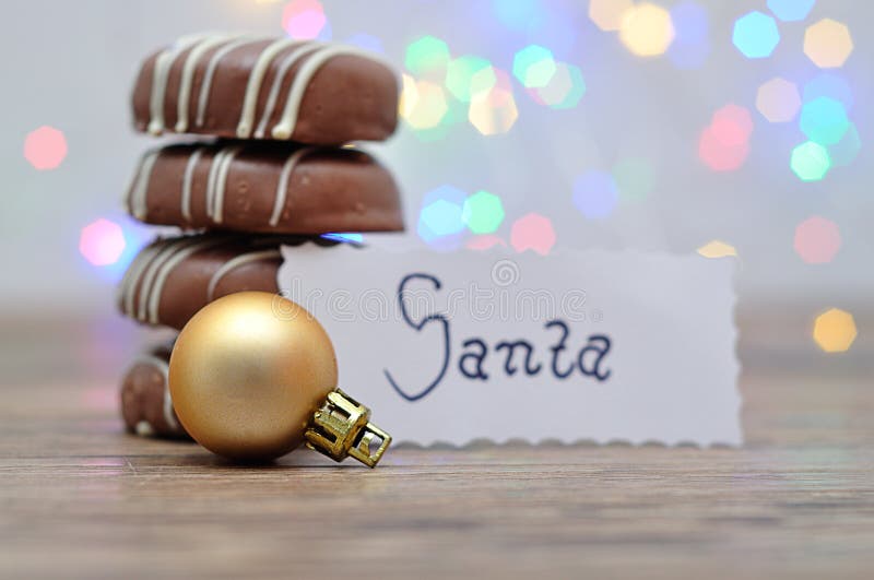 A Stack of Chocolate Covered Biscuits and a Golden Babble with a Note ...