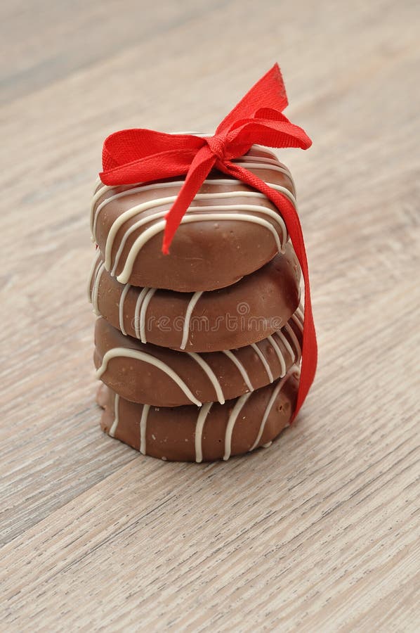 A Stack of Chocolate Covered Biscuits and a Golden Babble with a Note ...