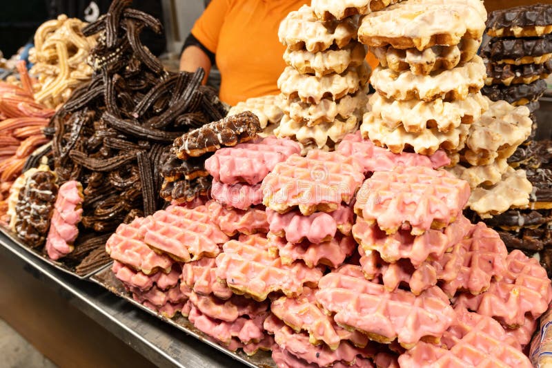Stack of Chocolate-covered Waffles and Churros at a Street Market Stall ...
