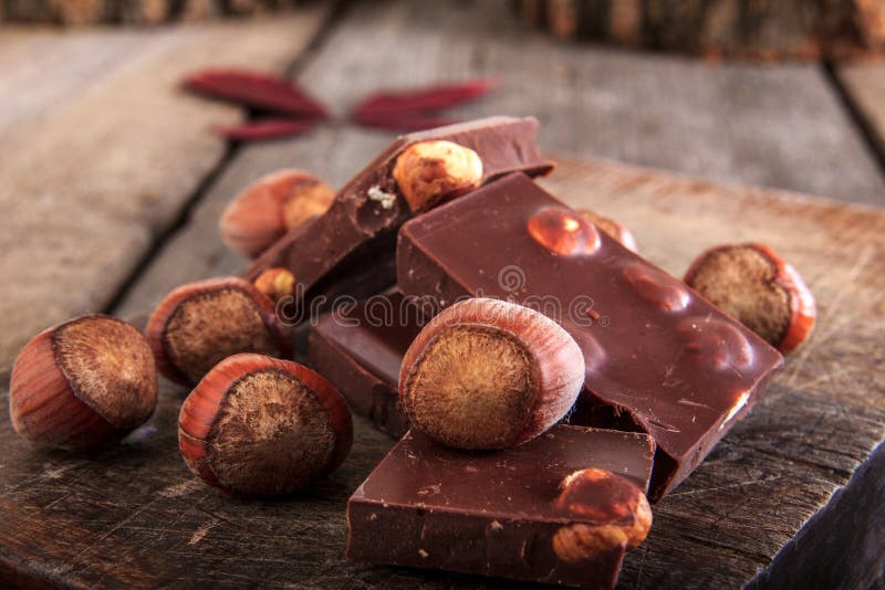 A Stack of Chocolate with Hazelnuts on Wooden Table Stock Image - Image ...