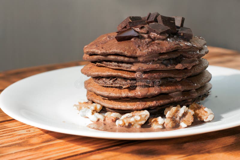 A Stack of Chocolate Pancakes Decorated with Liquid Chocolate Sauce ...