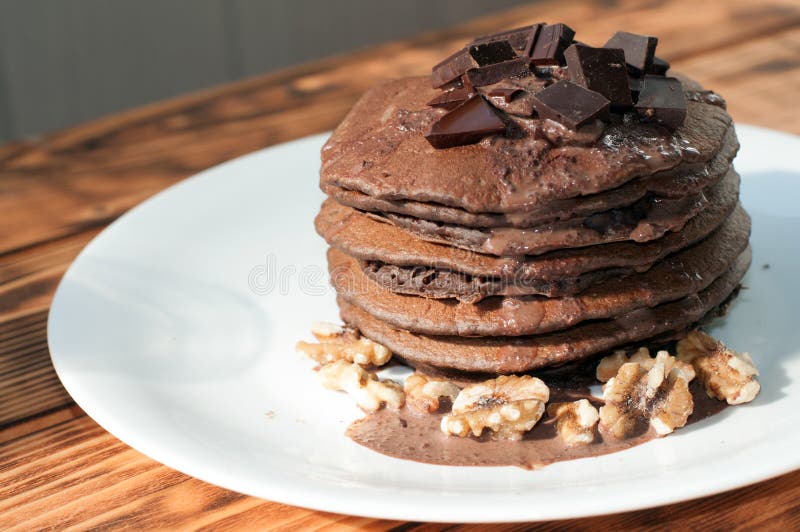 A Stack of Chocolate Pancakes Decorated with Liquid Chocolate Sauce ...
