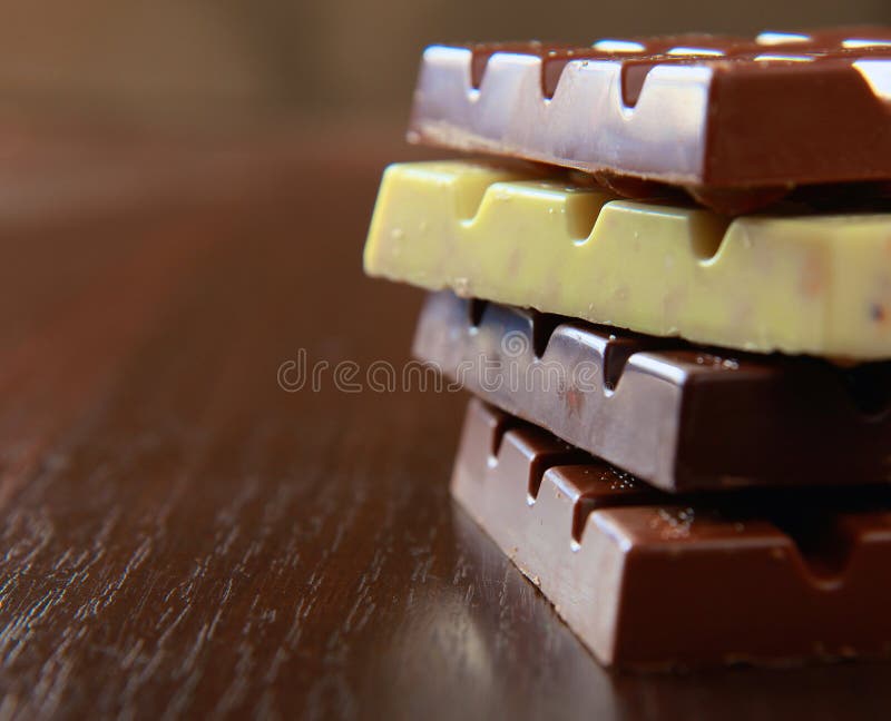 Stack of Chocolate Pieces on a Wood Background Stock Image - Image of ...