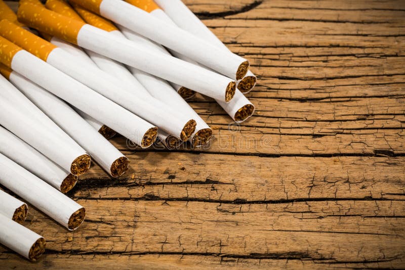Stack of Cigarette on Wood Table Stock Image - Image of individuality ...