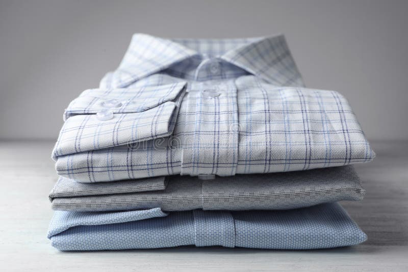 Stack of Classic Shirts on White Wooden Table Stock Photo - Image of ...