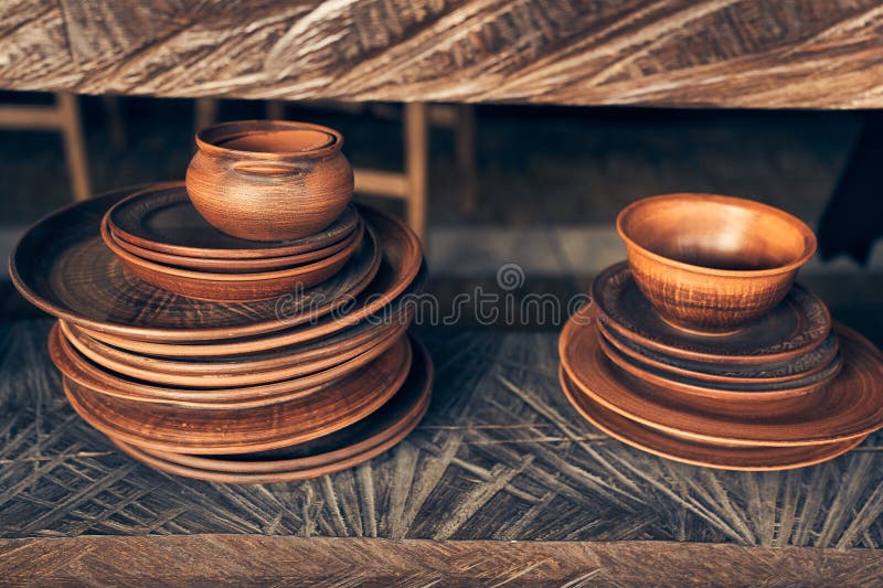 A Stack of Clay Plates of Different Sizes on a Dark Background. Level ...