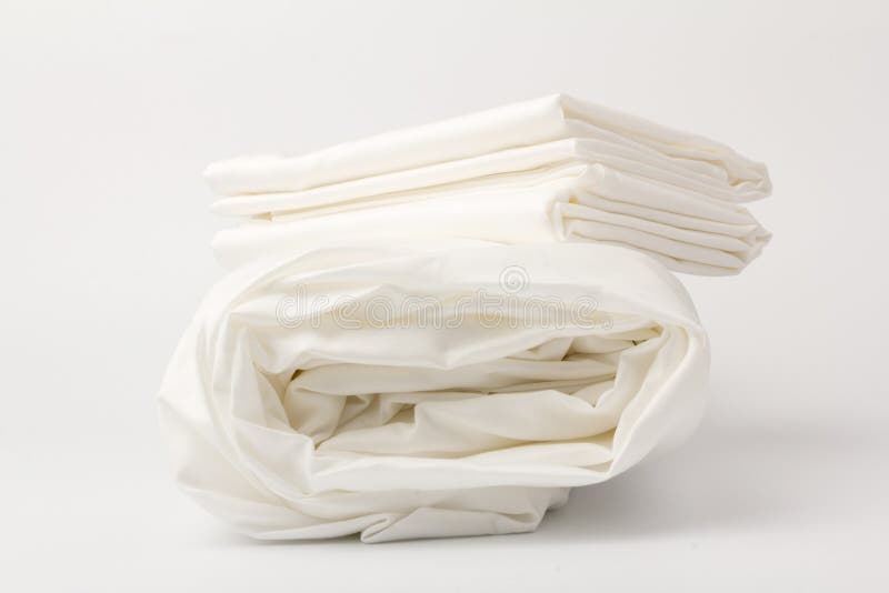 Stack of Clean Bed Sheets on White Background, Closeup Stock Photo ...