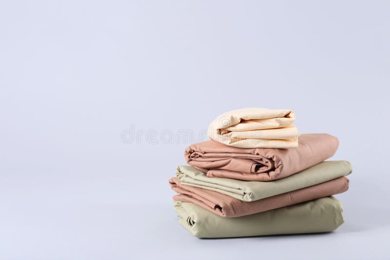 Stack of Clean Bed Sheets on White Background. Space for Text Stock ...
