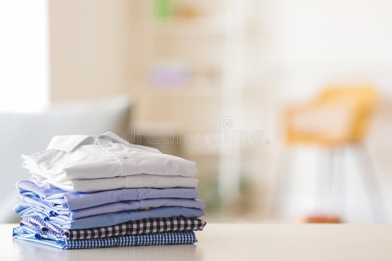 Stack of Clean Clothes on Table in Room Stock Photo - Image of sanitary ...