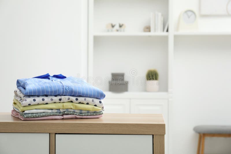 Stack of Clean Clothes on Wooden Dresser Indoors Stock Photo - Image of ...