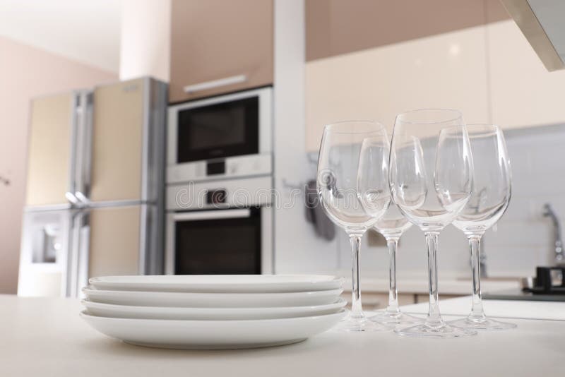 Stack of Clean Dishes and Glasses on Table Stock Photo - Image of ...