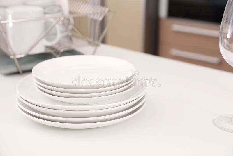 Stack of Clean Dishes on Table in Kitchen. Stock Image - Image of ...