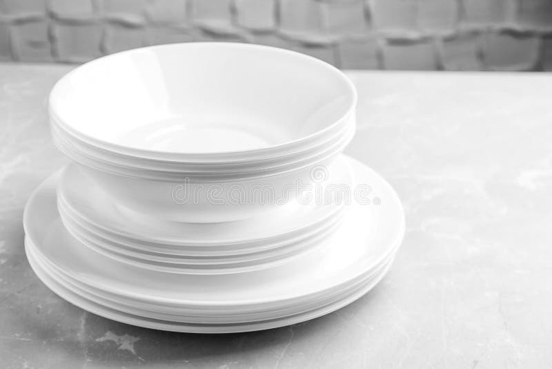 Stack of Clean Plates on Table Stock Image - Image of flatware ...