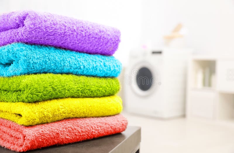 Stack of Clean Towels on Table in Laundry Room Stock Image - Image of ...