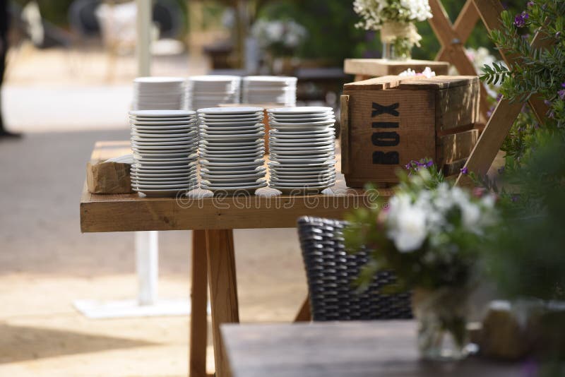 A Stack of Clean White Dishes on a Wooden Table Stock Photo - Image of ...