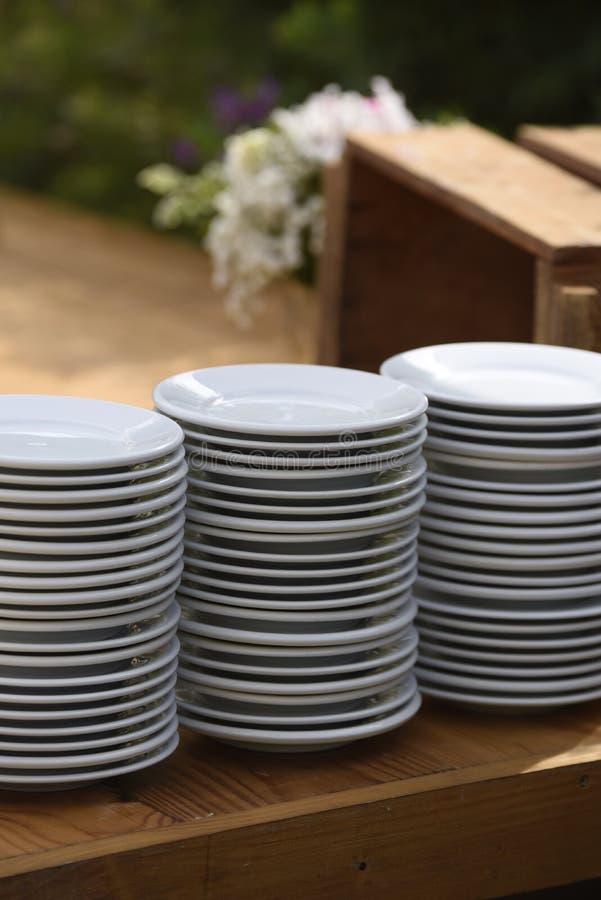 A Stack of Clean White Dishes on a Wooden Table Stock Image - Image of ...