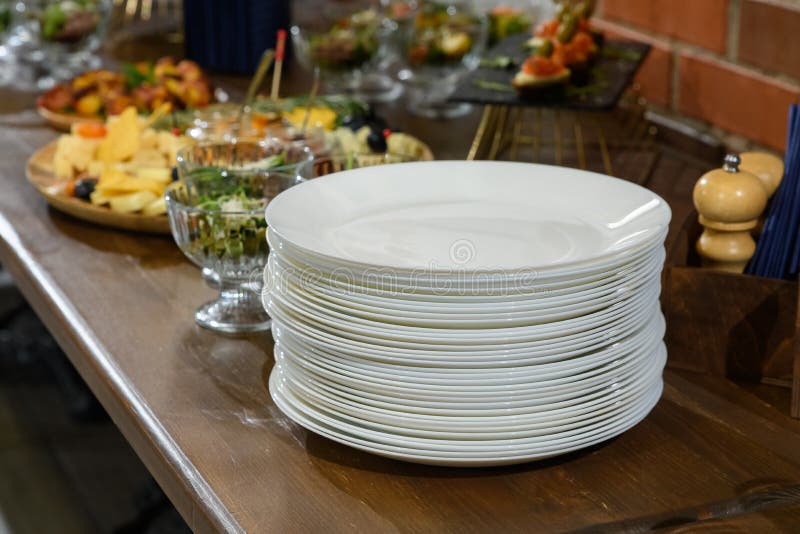 A Stack of Clean White Plates on the Food Table Stock Image - Image of ...