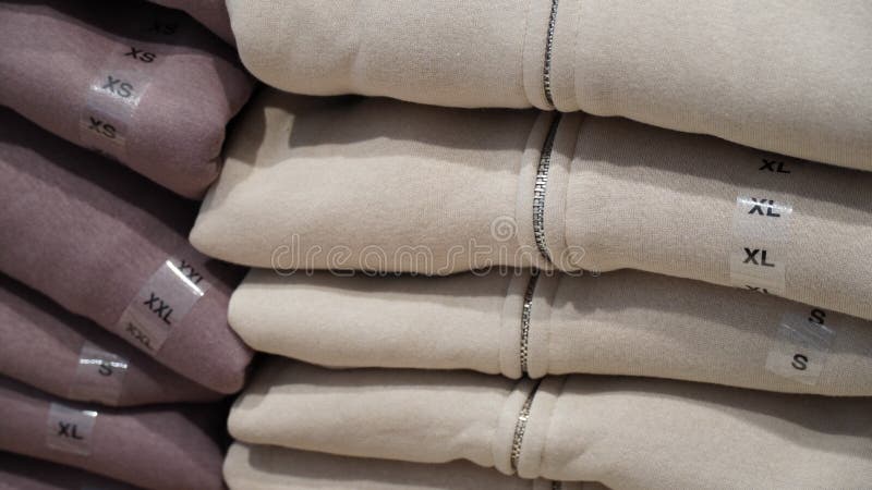 Stack of Cloth Different Colors and Sizes on the Shelves in a Clothes ...