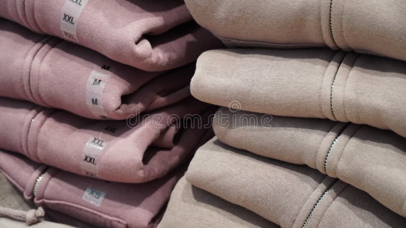 Stack of Cloth Different Colors and Sizes on the Shelves in a Clothes ...