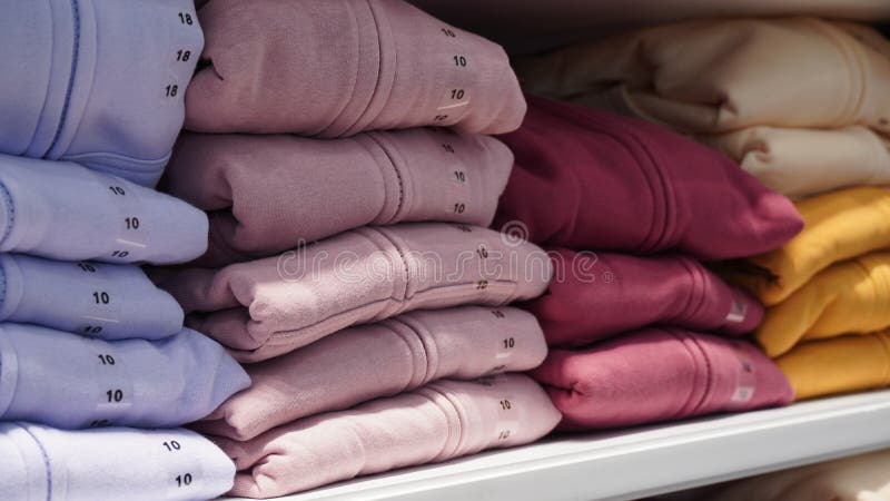 Stack of Cloth Different Colors and Sizes on the Shelves in a Clothes ...